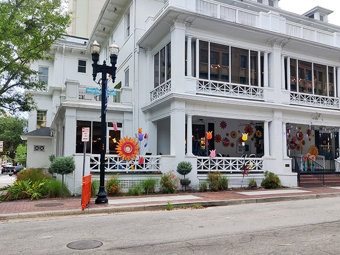 The grand white mansion housing Sweet Pete's stands like a sugar palace against Jacksonville's blue sky, promising sweet adventures within.