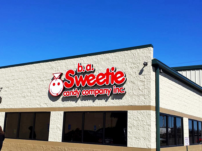 That iconic red signage against the cream-colored building is like a beacon for your inner child. Sweeties Candy Company stands ready to fulfill sugar-coated dreams.