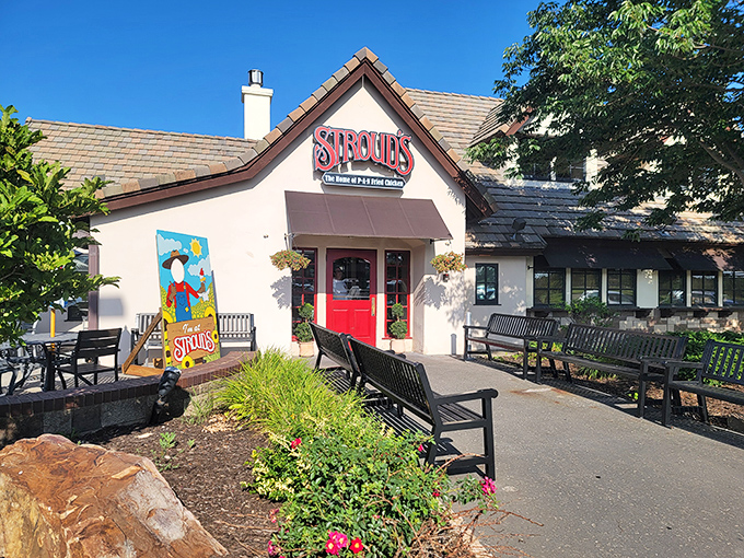 The red door at Stroud's stands like a portal to comfort food paradise, promising pan-fried delights beneath that charming pitched roof.