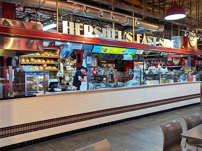 The neon "Deli" sign glows like a beacon of hope for the hungry. At Hershel's counter, sandwich artisans transform simple ingredients into edible masterpieces.