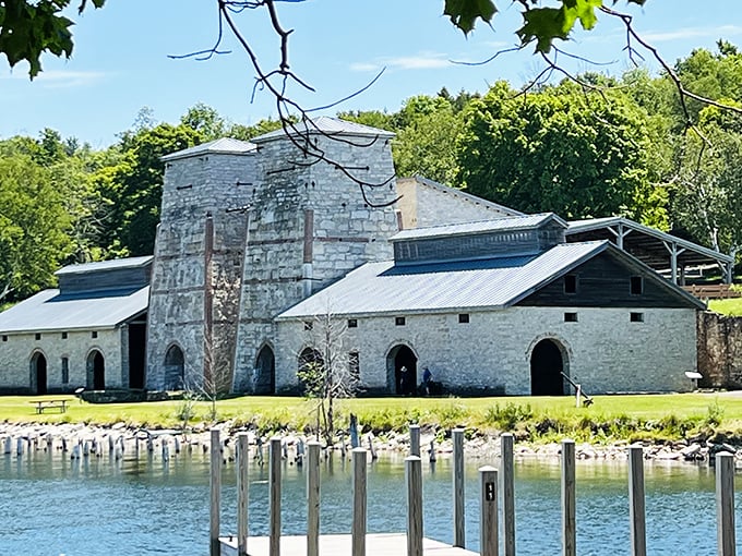 The imposing limestone blast furnaces stand like ancient temples against the azure waters of Snail Shell Harbor, a perfect marriage of industrial history and natural beauty.