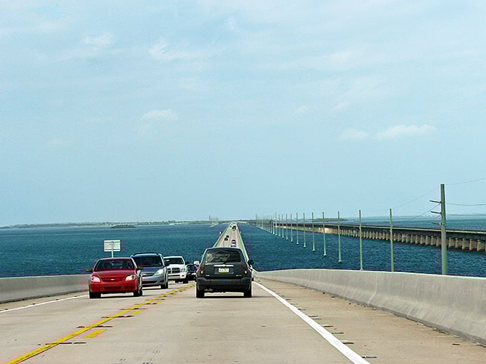 The highway seemingly floats between two infinite blues, making you question whether you're still on Earth or have somehow driven into a postcard.