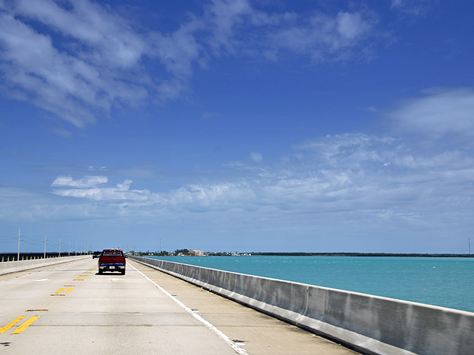 The highway seemingly floats between two infinite blues, making you question whether you're still on Earth or have somehow driven into a postcard. 