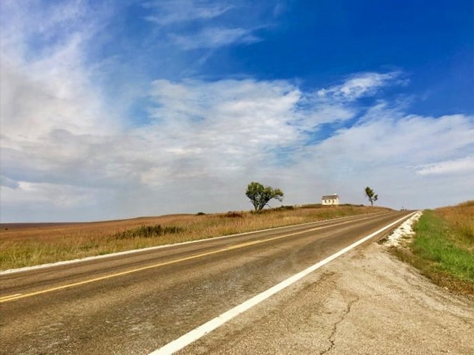 The road stretches toward infinity like nature's treadmill, minus the gym membership and with significantly better views.