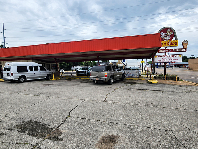 The iconic red-roofed Dog N Suds stands like a time capsule against the Arkansas sky, beckoning hungry travelers with promises of nostalgic delights.