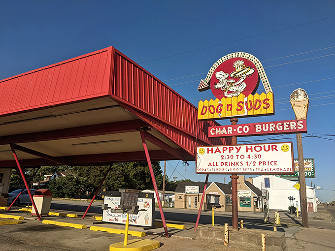 The iconic red-roofed Dog N Suds stands like a time capsule against the Arkansas sky, beckoning hungry travelers with promises of nostalgic delights.