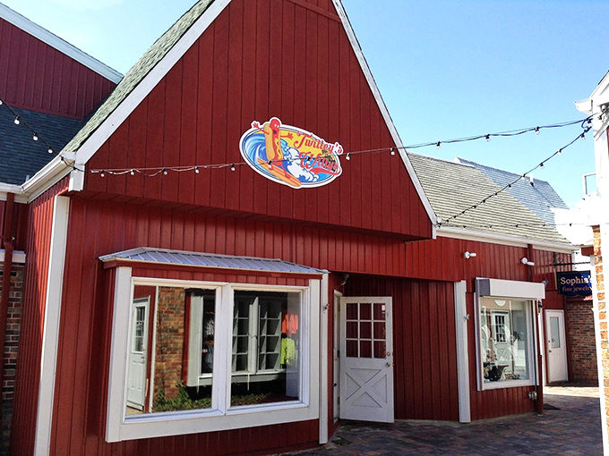 The iconic red barn exterior of Twilley's Willys stands like a beacon of hot dog hope against the Delaware sky, promising delicious adventures within.