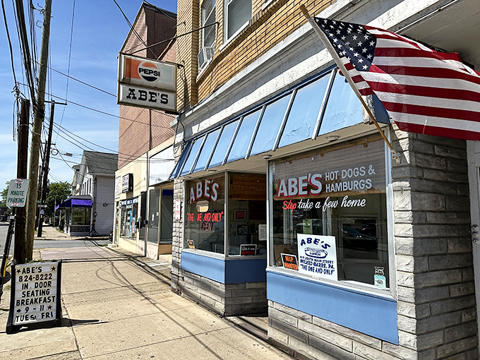 The classic American storefront that time forgot&mdash;complete with vintage sign, American flag, and the promise of comfort food that delivers on nostalgia. 