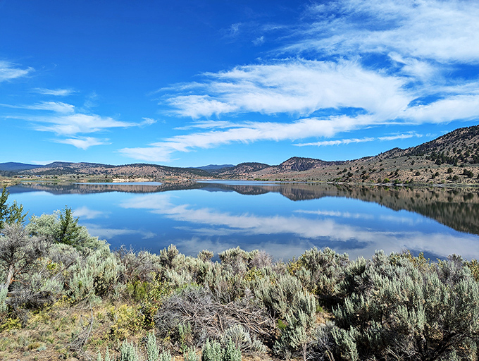 Mirror, mirror on the lake! Unity Lake's glassy surface reflects the sky like nature's own Instagram filter.