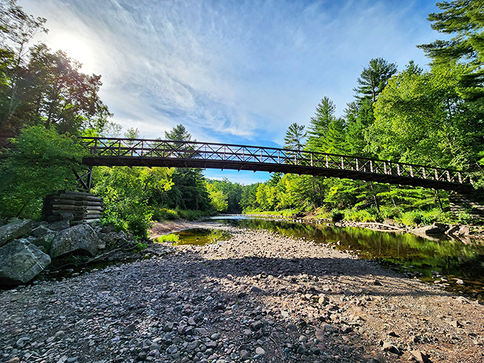 CCC-built bridges at Copper Falls connect visitors to nature's masterpiece, spanning time and the copper-tinted waters below.