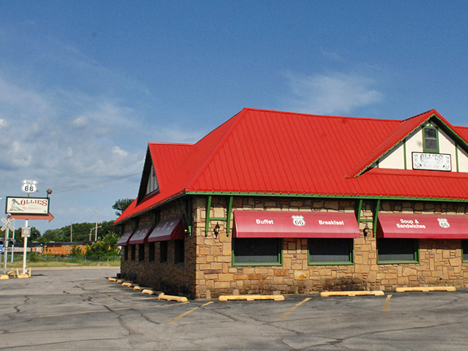 The stone exterior of Ollie's Station Restaurant stands like a welcoming depot, complete with vintage railway wagon and distinctive red roof that signals culinary adventures ahead.