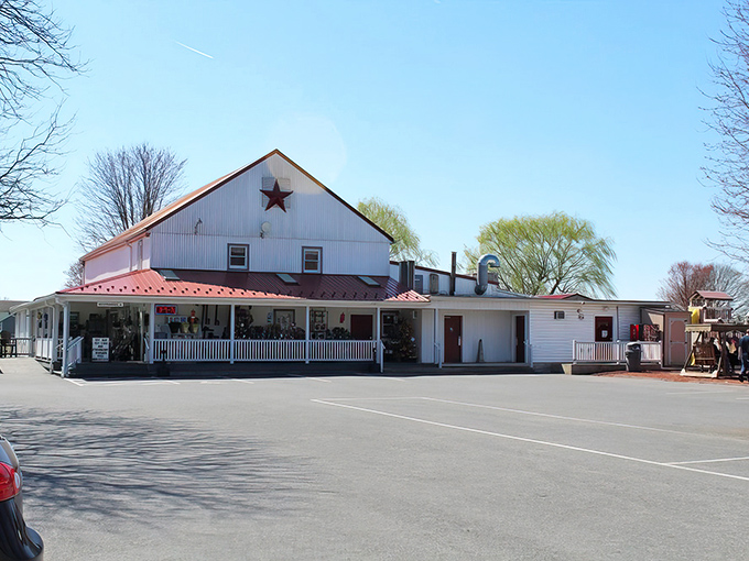 The classic white barn with its distinctive red roof stands as a beacon of baked goodness in Bird in Hand, Pennsylvania's rolling countryside. 