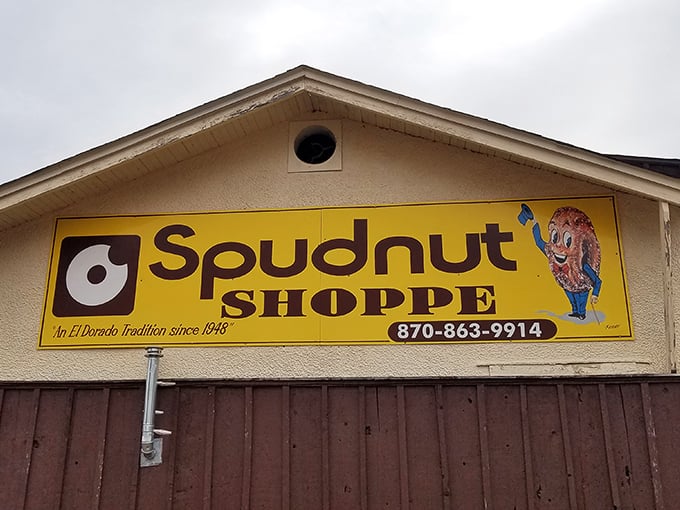 The bright yellow sign with its cartoon potato mascot stands as a cheerful time capsule from 1948, welcoming hungry visitors to El Dorado's sweetest tradition.