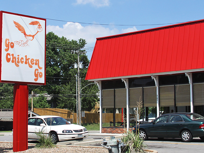 The iconic red-roofed building with its distinctive running chicken sign stands as a beacon of fried chicken perfection in Kansas City. 