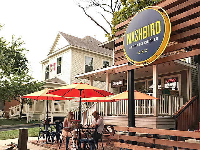 Nashbird's rustic wooden exterior isn't just Instagram-worthy&mdash;it's a siren call to chicken lovers everywhere. The circular yellow sign promises delicious things await.