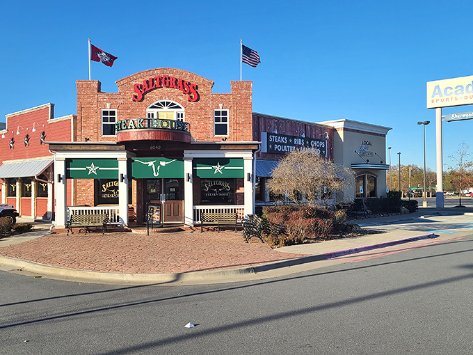 The brick facade of Saltgrass stands like a beacon of hope for hungry travelers. Those flags aren't just decoration&mdash;they're dinner semaphore.