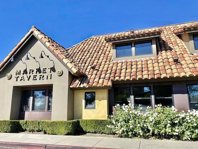 The Spanish-style terracotta roof and inviting facade of Market Tavern stands like a Mediterranean oasis in Dublin, California's suburban landscape.