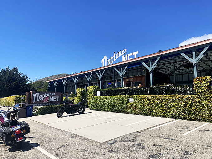 Where motorcycles meet the sea: Neptune's Net stands proudly along PCH, a weathered wooden beacon for hungry travelers and weekend riders alike.