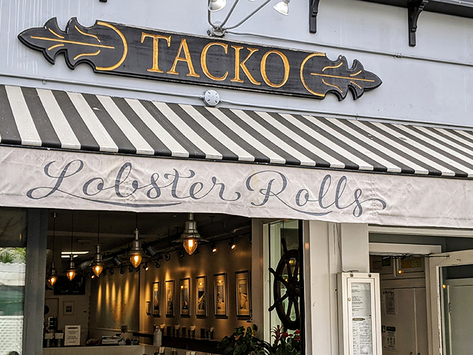 The iconic Tacko storefront proudly announces its dual culinary citizenship with "Tacos," "Lobster Rolls," and "Burritos" emblazoned on its cheerful awning.