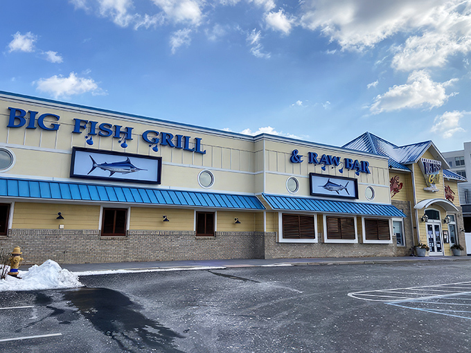 The cheerful yellow exterior of Big Fish Grill beckons like a maritime lighthouse for hungry souls. Blue accents and nautical touches promise seafood salvation ahead.