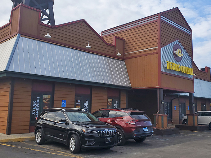The iconic Texas Corral exterior stands like a Western movie set in suburban Indiana, complete with that charming water tower that says "yes, serious beef happens here."