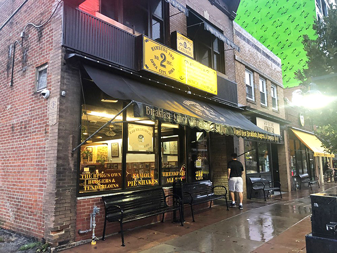 That iconic yellow awning boldly proclaiming "HAMBURGERS PIESHAKES" is like a beacon of comfort food hope on an Iowa City street corner.
