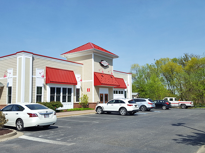 The unassuming exterior of Adams Grille & Tap House with its signature red roof beckons like a barbecue lighthouse guiding hungry travelers home.