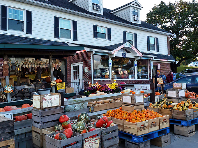 The classic white colonial exterior of Baugher's stands like a beacon of comfort food promise against Maryland's blue skies.