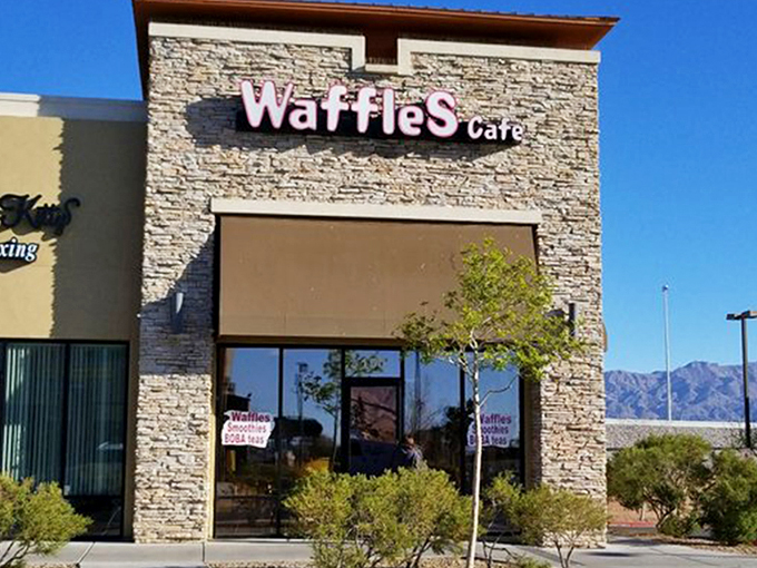 The stone facade of Waffles Cafe stands like a humble temple to breakfast, promising griddle-based salvation away from the neon chaos of the Strip.
