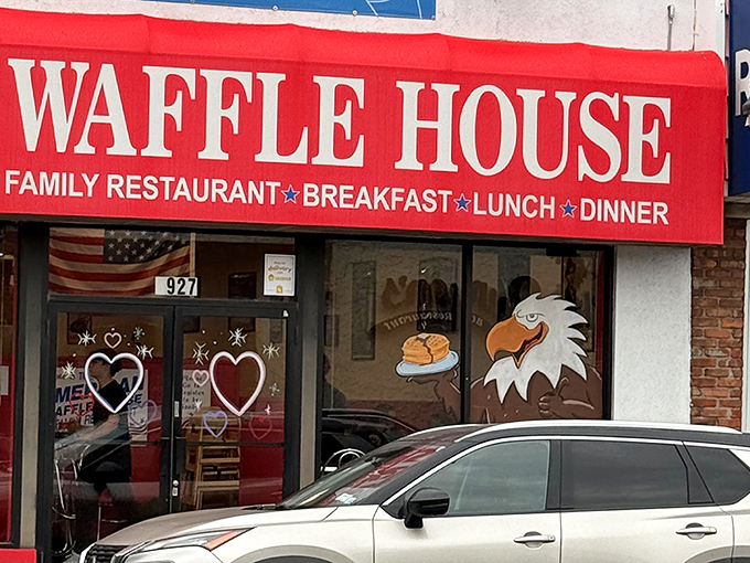 The bright red exterior of American Waffle House stands like a beacon of breakfast hope on Merrick Road. Resistance is futile.