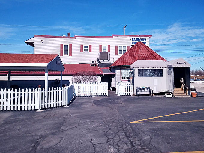 The unassuming white clapboard exterior of Brennan's Fish House stands like a beacon for seafood lovers, its distinctive red-shingled roof a landmark in Grand River.