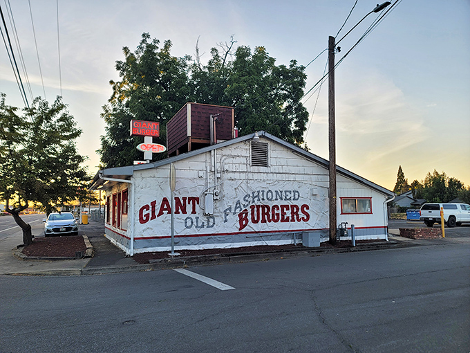 The iconic red and white Giant Burger sign stands tall against the Oregon sky, beckoning hungry travelers like a lighthouse for the famished.