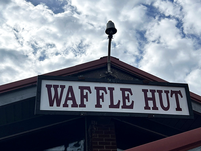 The modest sign says "WAFFLE HUT" but might as well read "Breakfast Paradise Ahead." Sometimes the most unassuming exteriors hide the greatest culinary treasures.