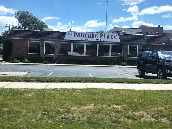 The unassuming exterior of The Pancake Place stands like a breakfast lighthouse, beckoning hungry travelers through Green Bay's morning fog with promises of pancake perfection.