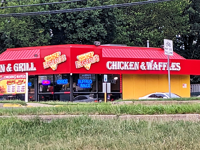 The neon glow of Legends beckons like a lighthouse for the hungry, promising salvation in the form of perfectly fried chicken as dusk settles over Hyattsville.