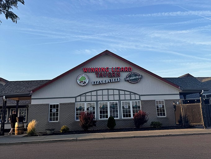 The Winking Lizard's welcoming glow beckons hungry travelers like a lighthouse for the gastronomically adrift. Come for the crab cakes, stay for everything else.
