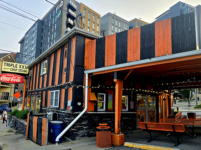 The iconic orange and black striped exterior of Triple XXX stands like a time capsule on the hill, beckoning hungry travelers with its vintage Coca-Cola signage and timeless charm.