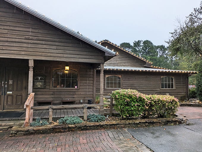 Rustic charm meets carnivore's paradise at this unassuming wooden cabin. The brick pathway practically whispers, "Follow me to steak nirvana."