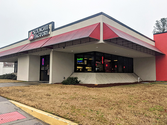 The bright red awning of Kolache Factory stands out like a culinary lighthouse, beckoning carb enthusiasts to discover Czech-inspired delights inside.