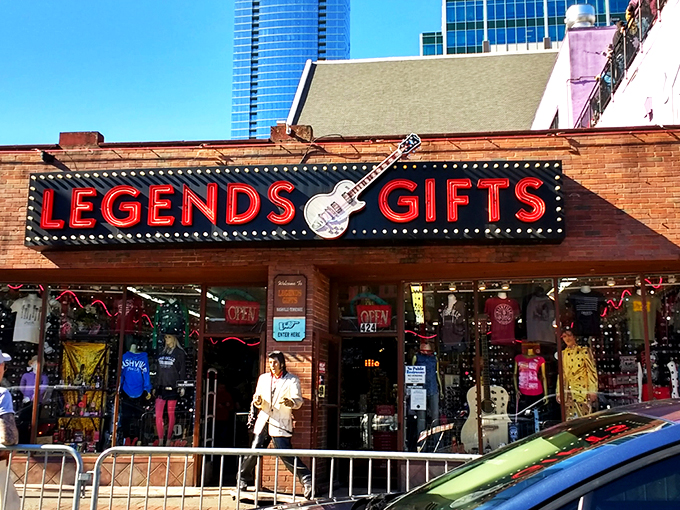 The iconic red Legends Gifts storefront beckons like a siren song to Nashville visitors. That guitar silhouette isn't just decoration&mdash;it's a promise of melodious treasures within.