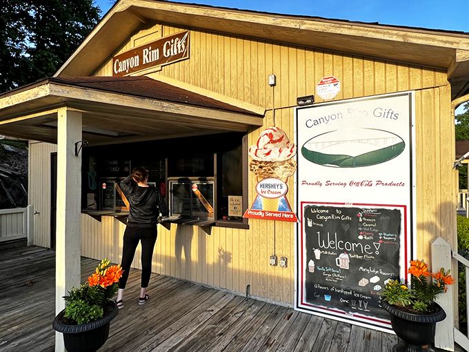 The sunny yellow exterior of Canyon Rim Gifts beckons travelers like a folksy lighthouse amid the West Virginia mountains, promising treasures within. 