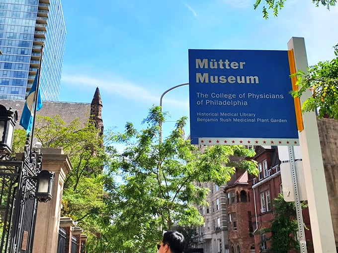 The iconic blue sign welcomes curious minds to Philadelphia's temple of medical marvels, standing bright against the city skyline like a beacon for the wonderfully weird. 