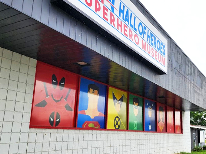 The unassuming exterior belies what waits inside - a fa&ccedil;ade featuring iconic superhero emblems that serve as a bat-signal to comic enthusiasts everywhere.