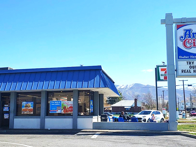 The iconic blue roof of Arctic Circle stands like a beacon of comfort food against the Utah sky, promising fry sauce nirvana within.