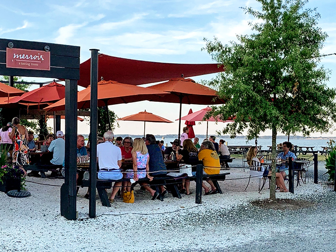 Merroir's unassuming exterior belies the culinary magic within. Those orange umbrellas aren't just for shade&mdash;they're beacons guiding seafood pilgrims to paradise.