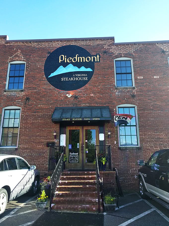 The historic brick facade of Piedmont Steakhouse welcomes you with understated elegance. Those bright blue planters aren't just decoration&mdash;they're your first hint that something special awaits inside.