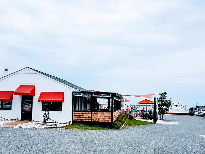The entrance to seafood paradise - a humble wooden structure with bright orange awnings where Chesapeake Bay magic happens daily.