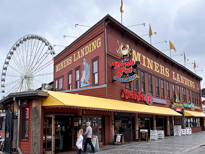 The iconic red crab sign beckons seafood lovers like a crustacean lighthouse on Seattle's waterfront, promising maritime delights within the rustic wooden building.