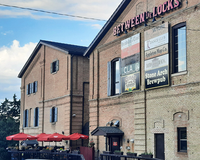 Stone Arch Brewpub's historic brick exterior with blue shutters stands as Appleton's answer to "where should we eat tonight?" Timeless charm meets modern craft brewing.