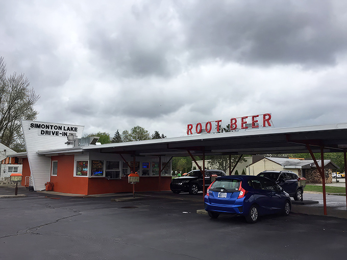 The classic neon "ROOT BEER" sign glows like a beacon to hungry travelers, promising nostalgic flavors under the Indiana sky.